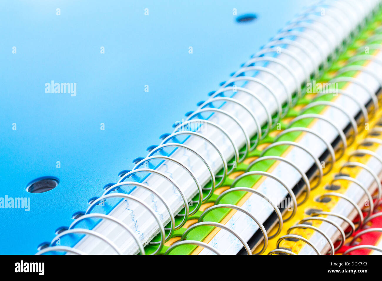 Multicolored spiral notebooks on a white background Stock Photo - Alamy