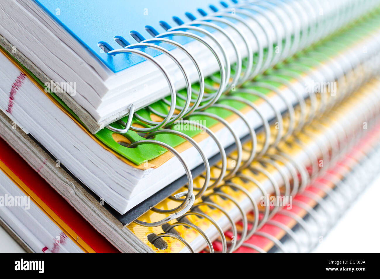 Multicolored spiral notebooks on a white background Stock Photo - Alamy