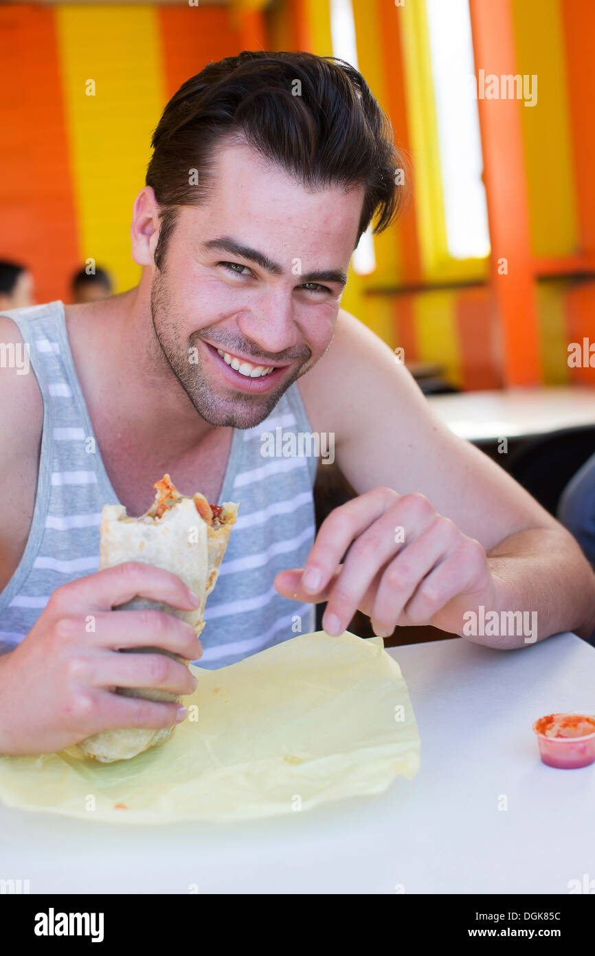 Man enjoying Lebanese bread wrap Stock Photo - Alamy