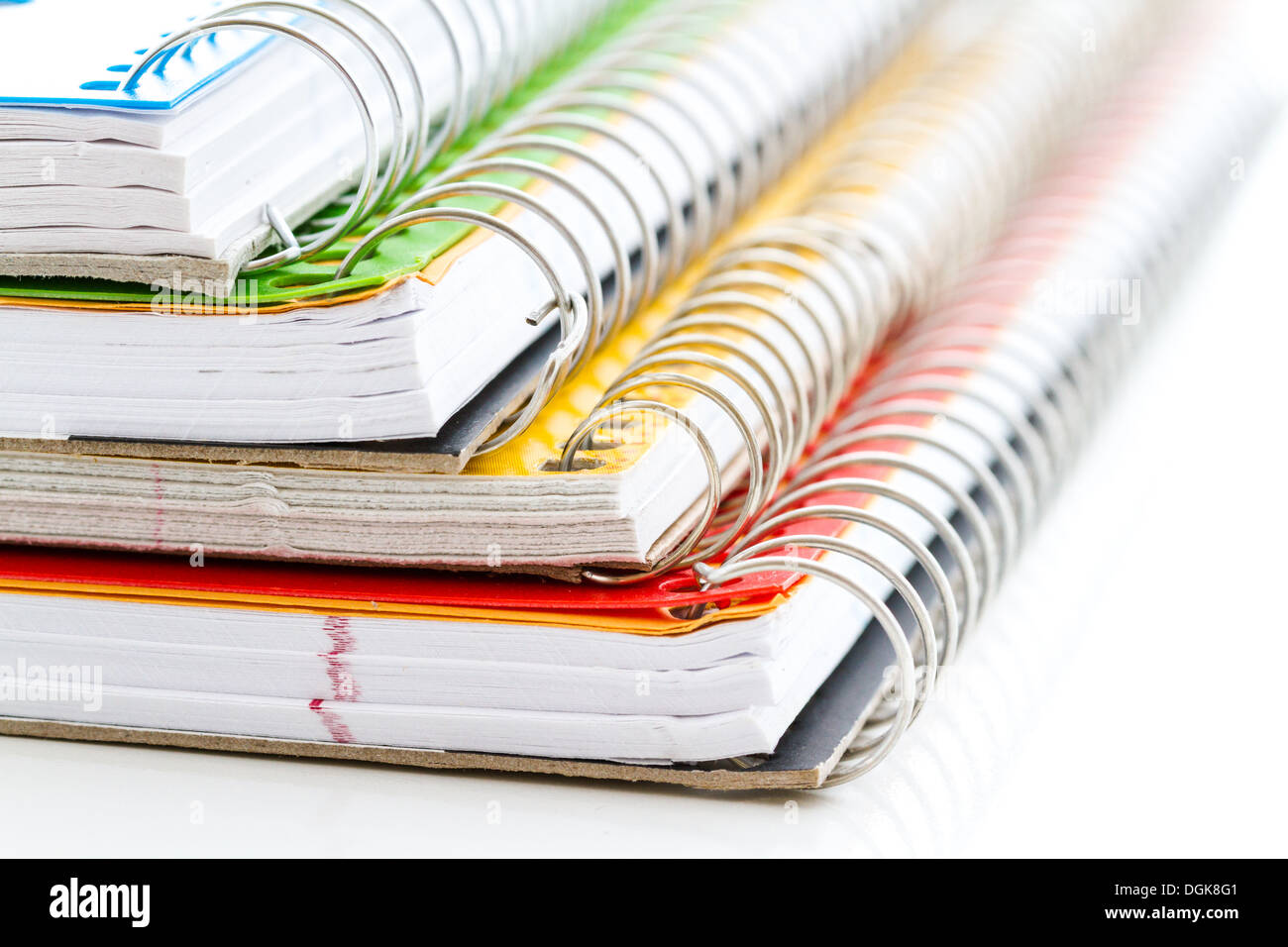 Multicolored spiral notebooks on a white background Stock Photo - Alamy