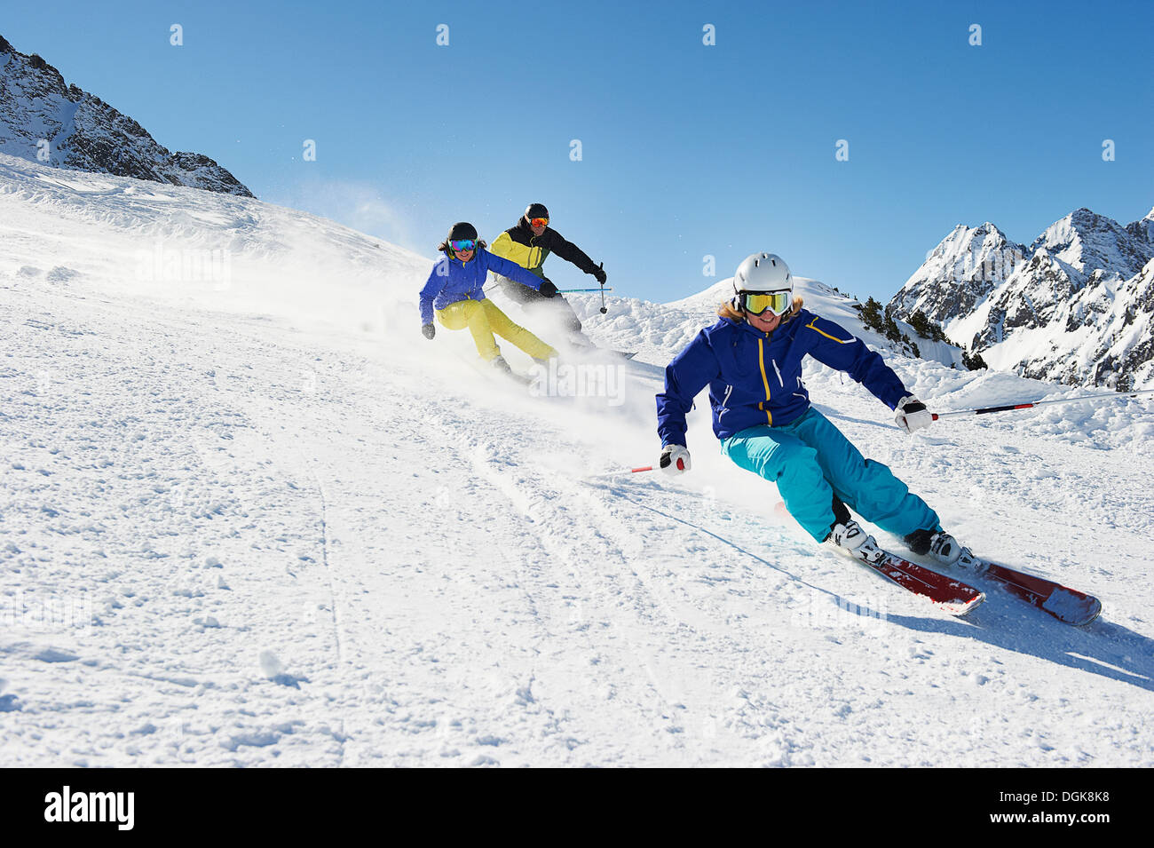 Three skiers going downhill hi-res stock photography and images - Alamy