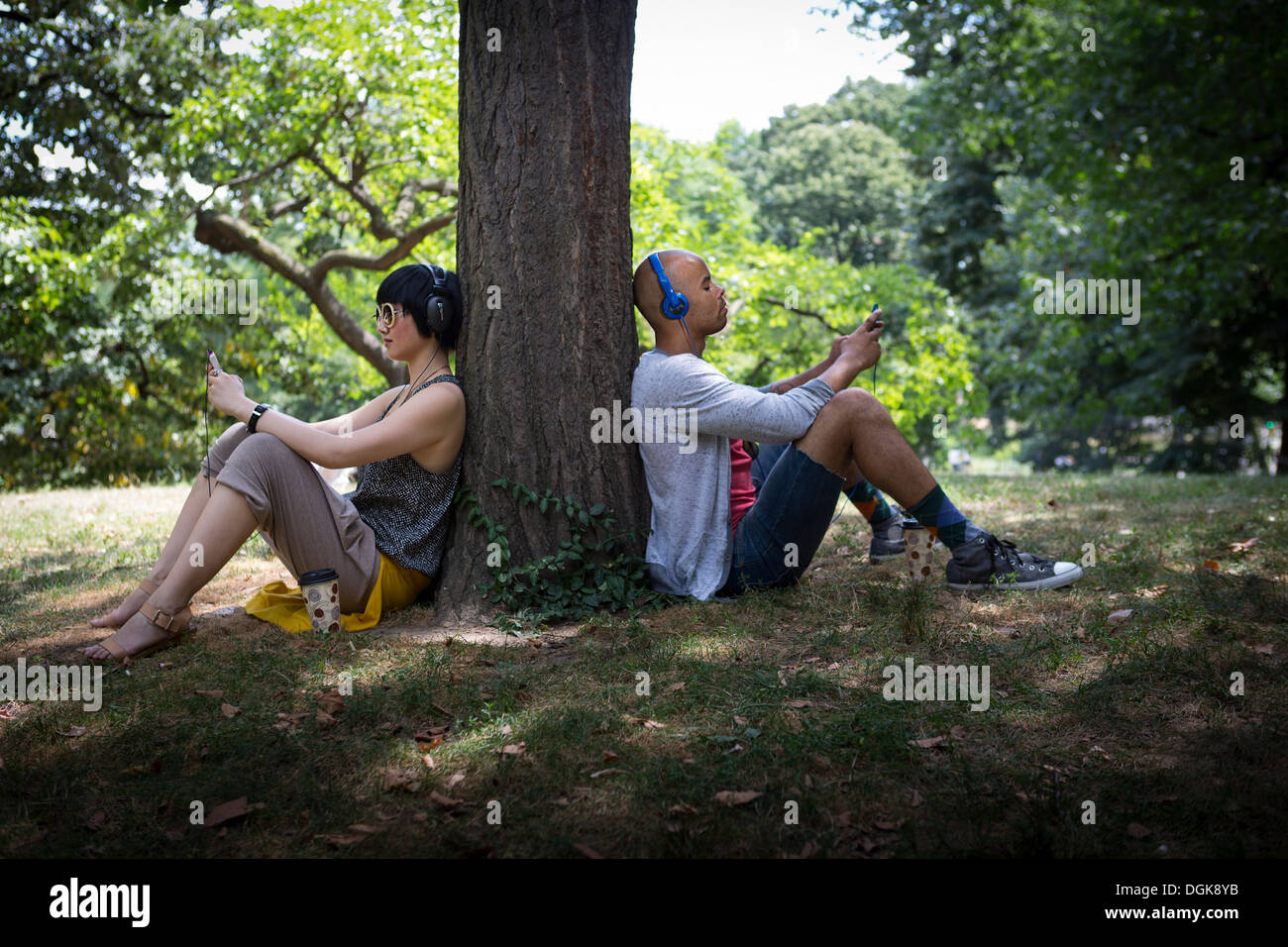 Woman Sitting Against Tree Trunk High Resolution Stock Photography and ...