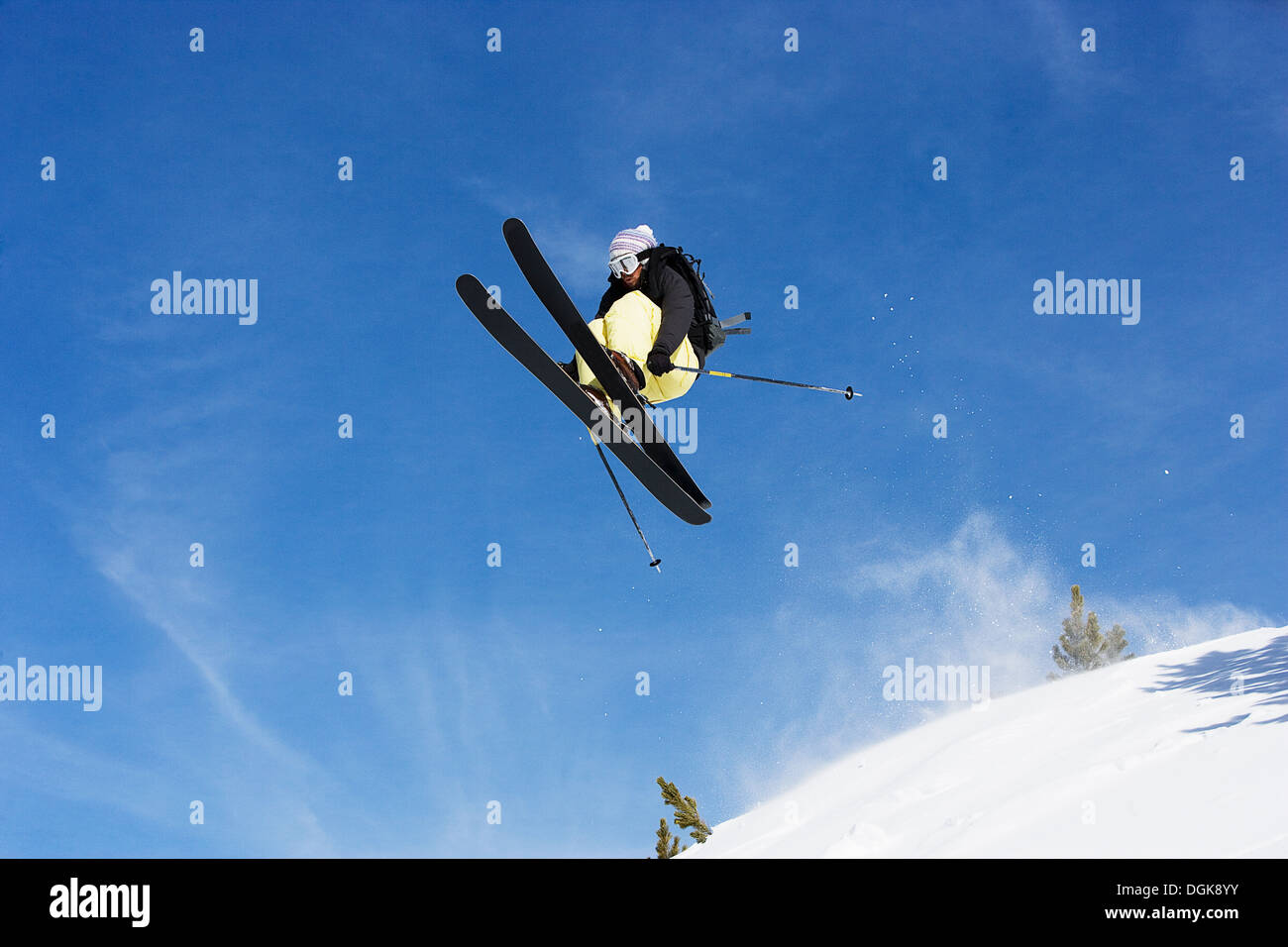 Male skier jumping mid air on mountain Stock Photo - Alamy