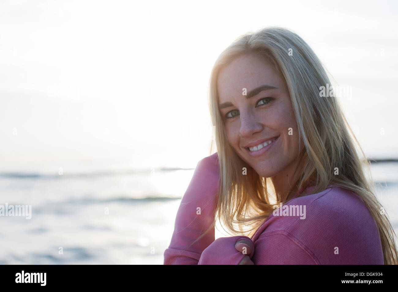 Woman looking sideways at camera Stock Photo - Alamy