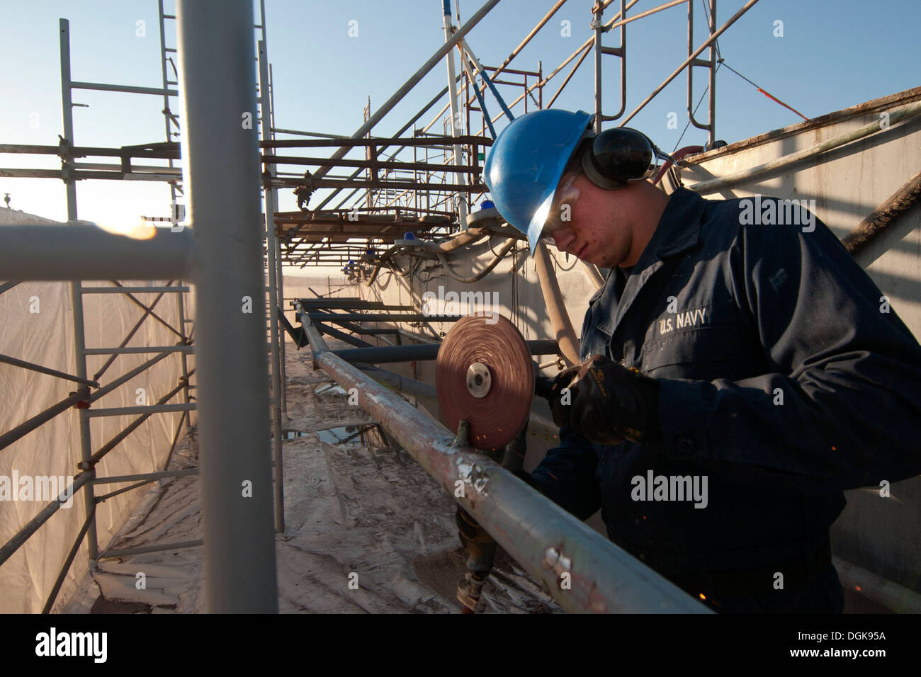 SAN DIEGO (Oct. 18, 2013) – Airman Kade Prince uses a disk sander to ...