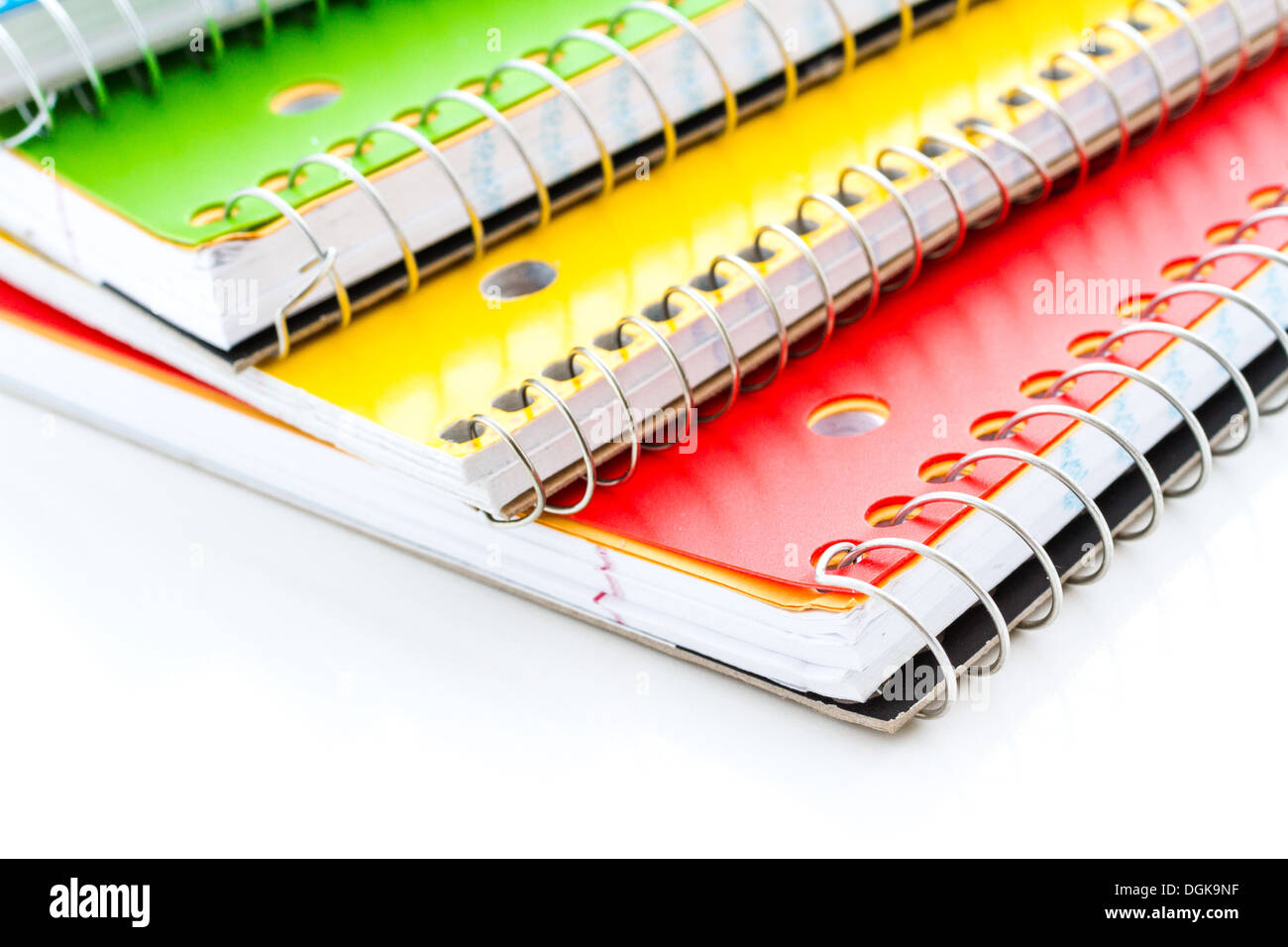 Multicolored spiral notebooks on a white background Stock Photo - Alamy