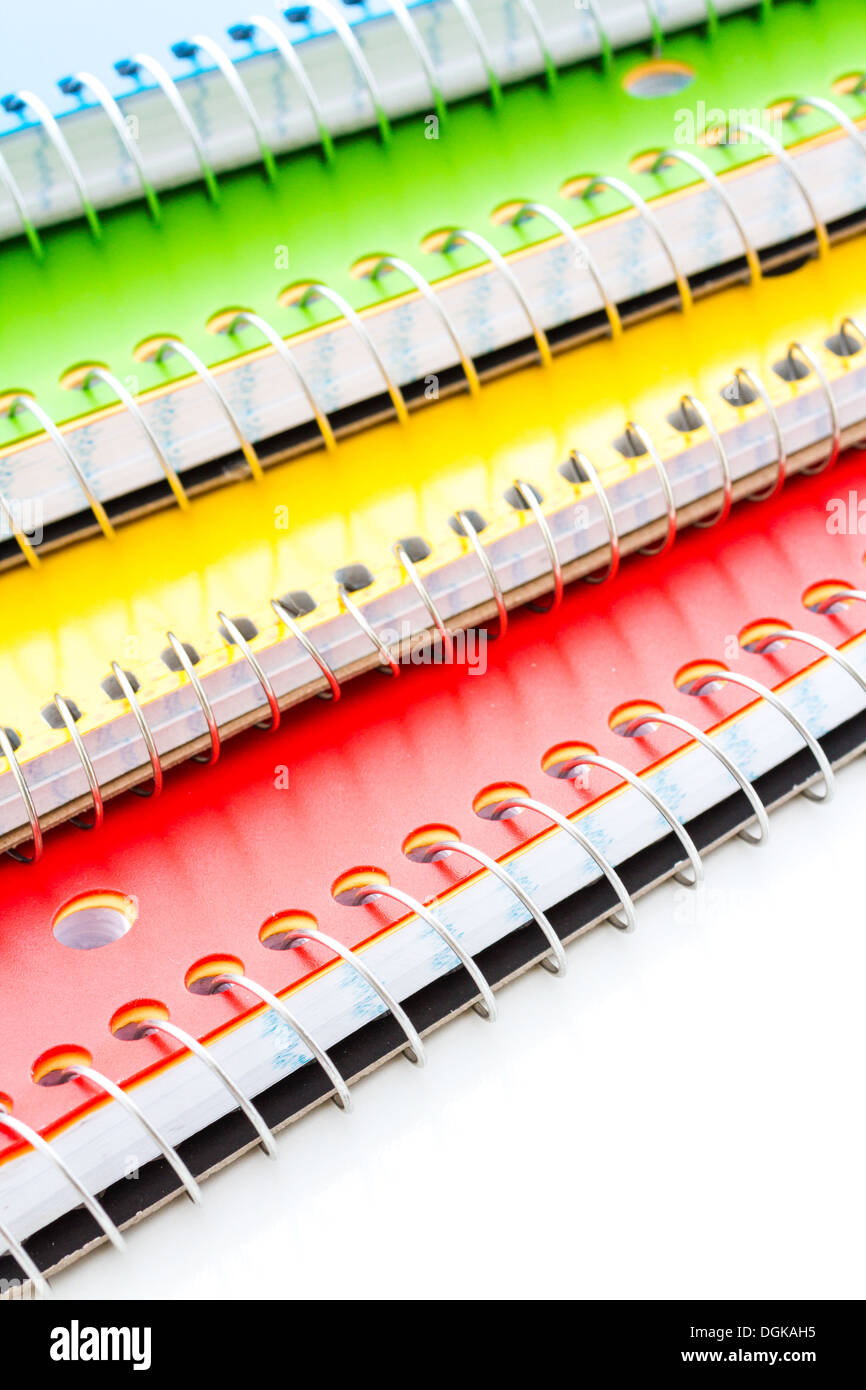 Multicolored spiral notebooks on a white background Stock Photo - Alamy