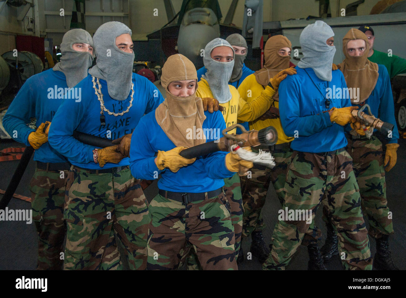 Sailors fight a simulated fire during a mass casualty drill in the ...