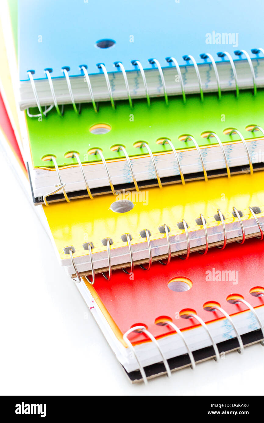 Multicolored spiral notebooks on a white background Stock Photo - Alamy