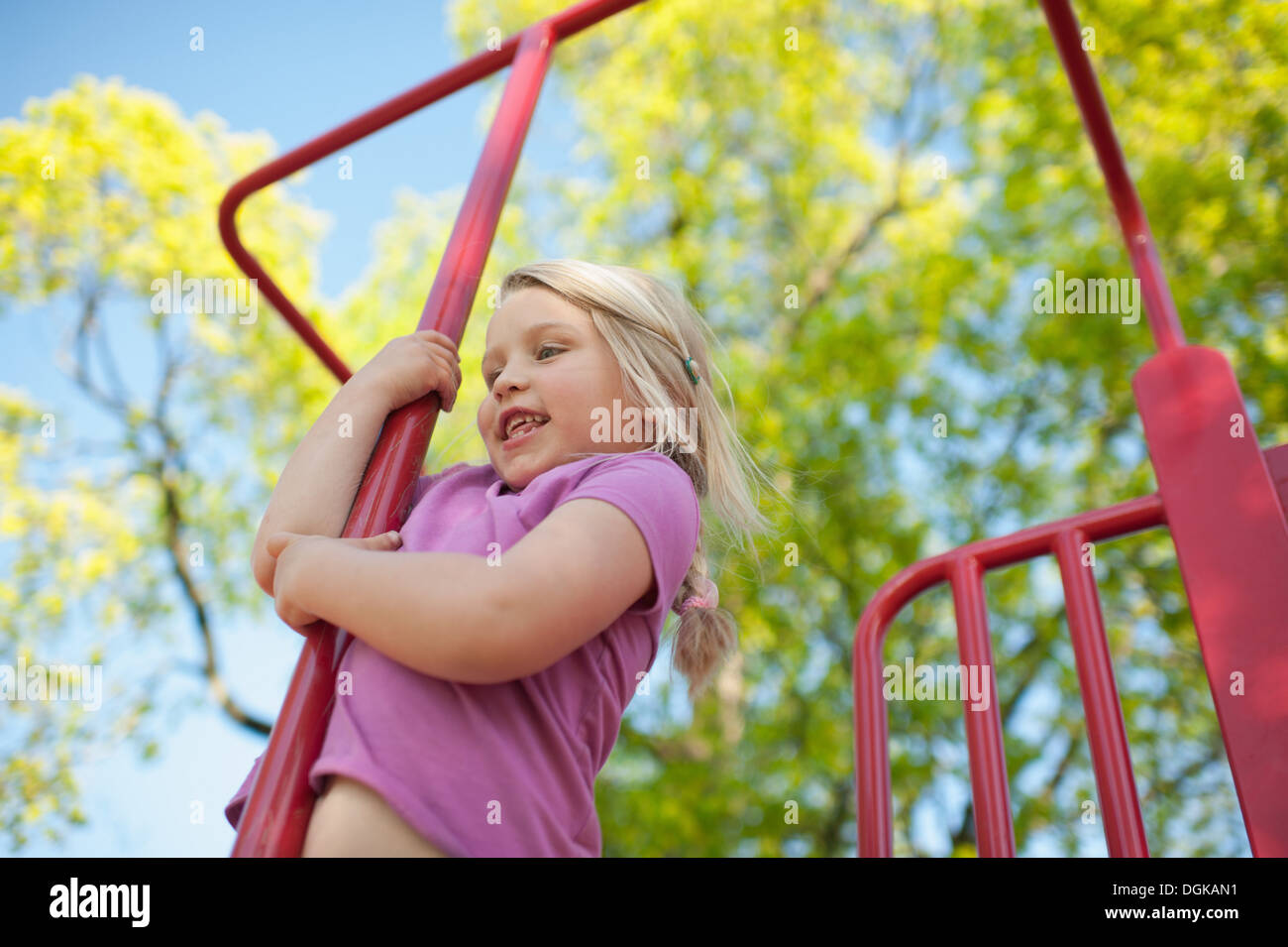 Girl on climbing frame Stock Photo - Alamy