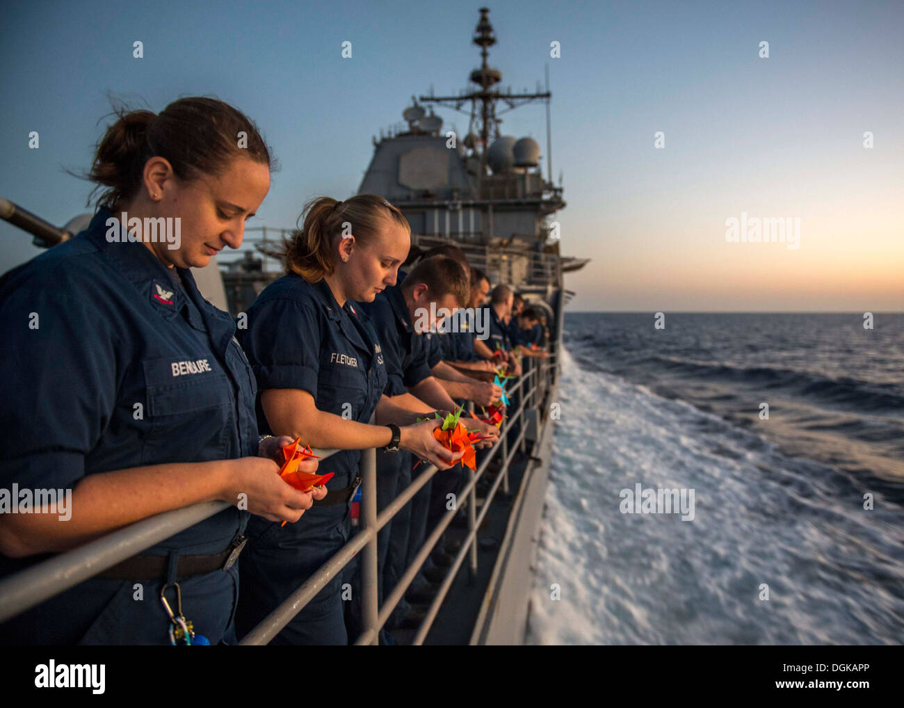 Sailors aboard the guided-missile cruiser USS San Jacinto (CG 56) pray ...