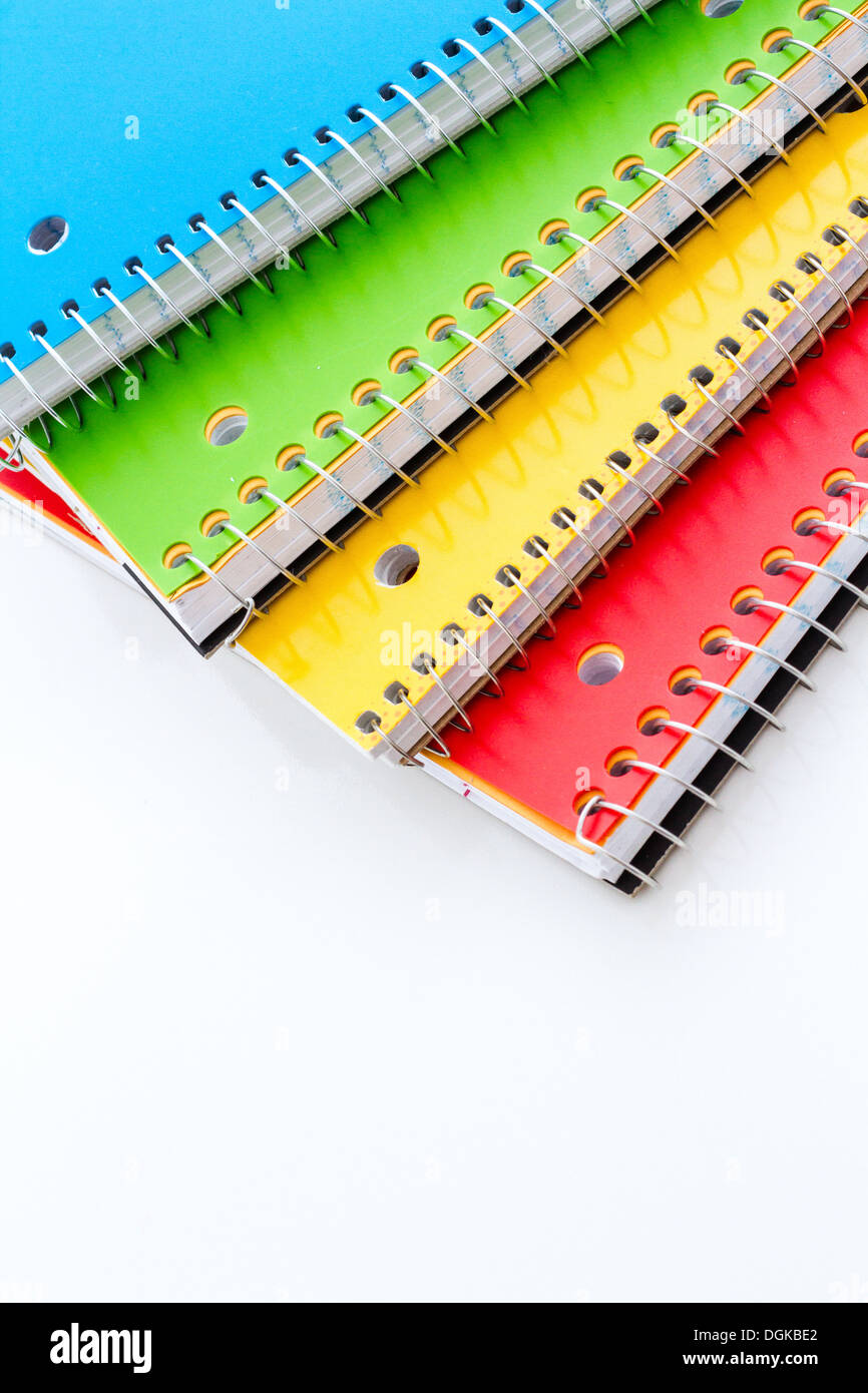 Multicolored spiral notebooks on a white background Stock Photo - Alamy