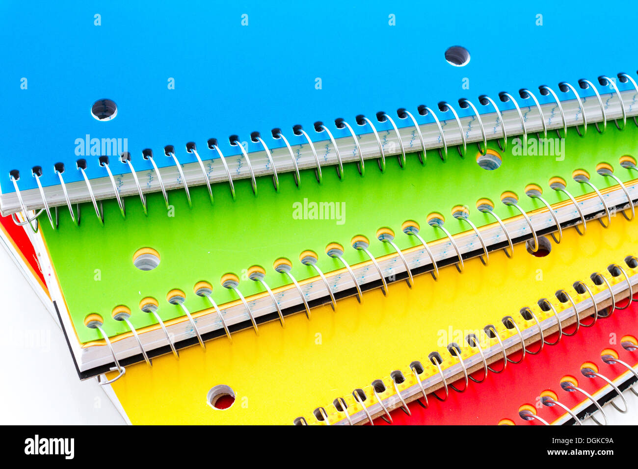 Multicolored spiral notebooks on a white background Stock Photo - Alamy