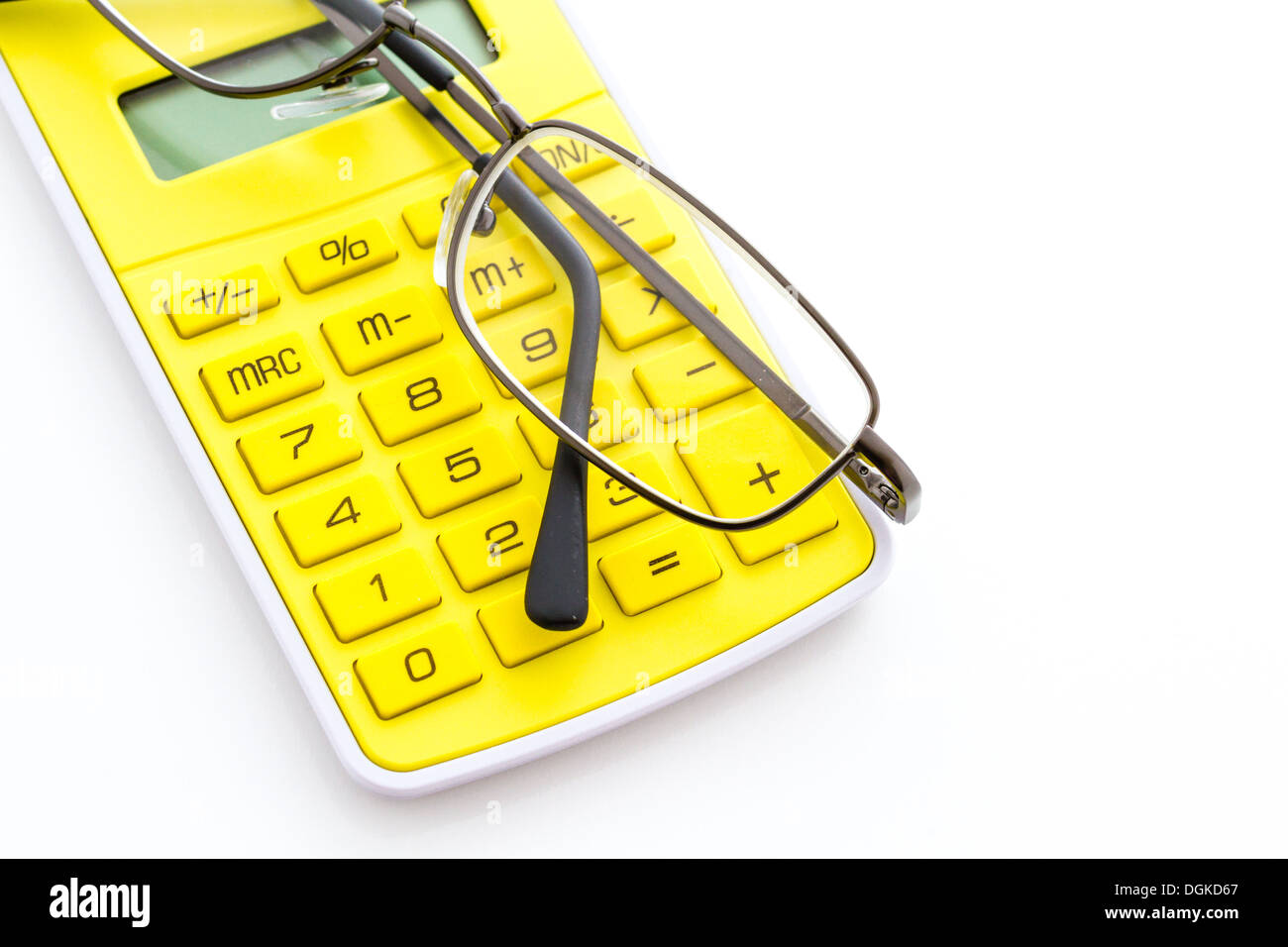 Simple yellow calculator with reading glasses on a white background ...