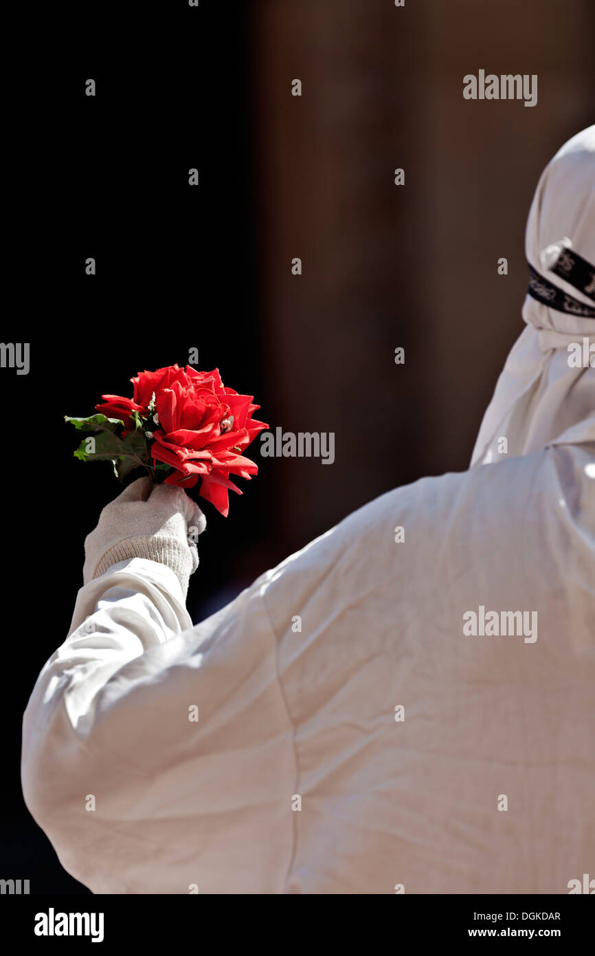 Close up of a street performer holding a red rose in Piazza Maggiore in ...