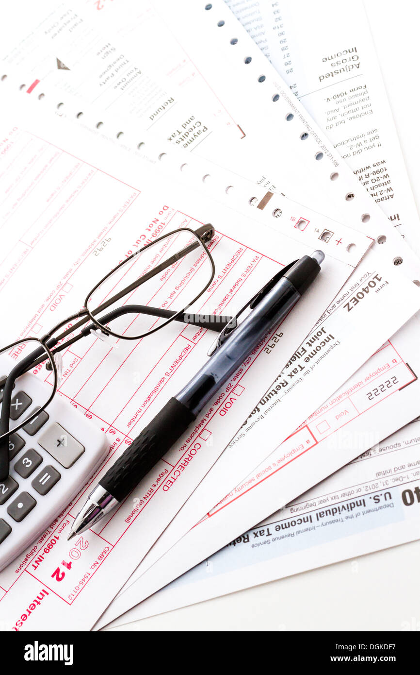 Calculating numbers for income tax return with pen and calculato Stock ...