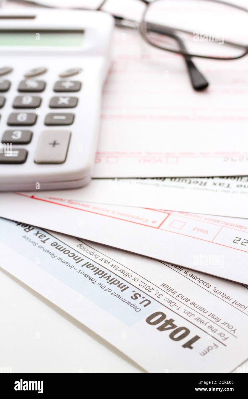Calculating numbers for income tax return with pen and calculato Stock ...