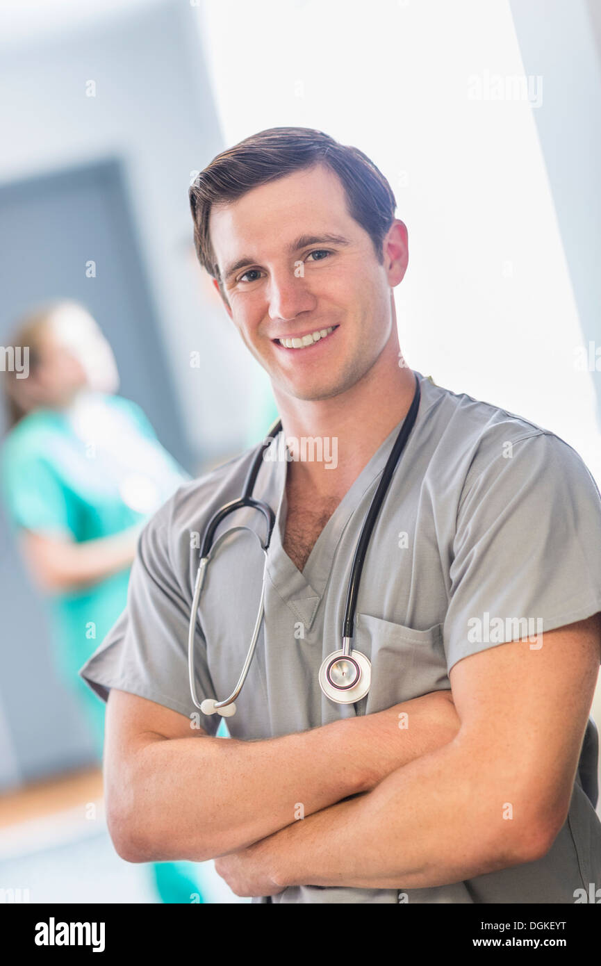 Doctor smiling in hospital hallway hi-res stock photography and images ...