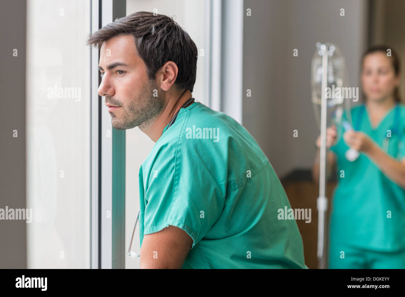 Doctor looking out window Stock Photo - Alamy