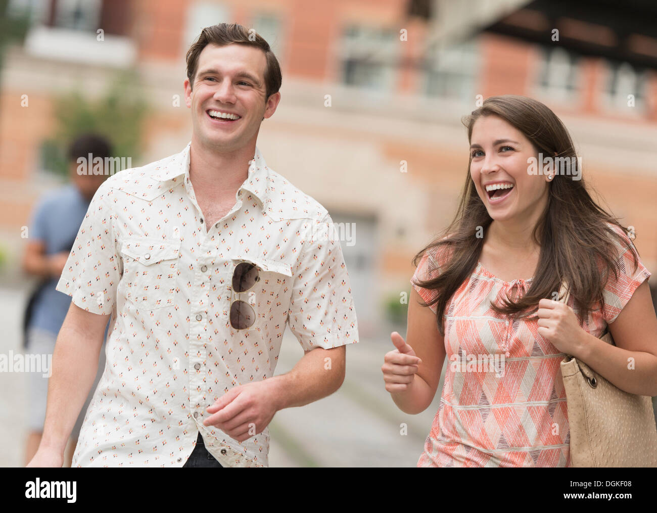 Urban couple laughing Stock Photo - Alamy