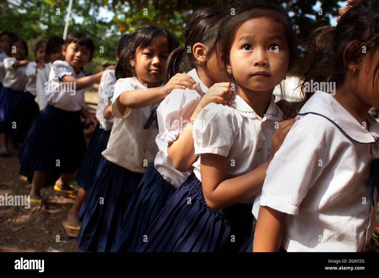School girls line up after recess in a village school near Battambang ...