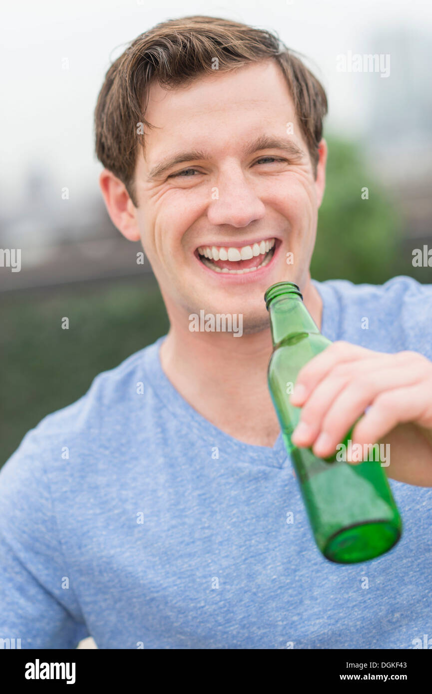 Portrait of man drinking beer Stock Photo - Alamy