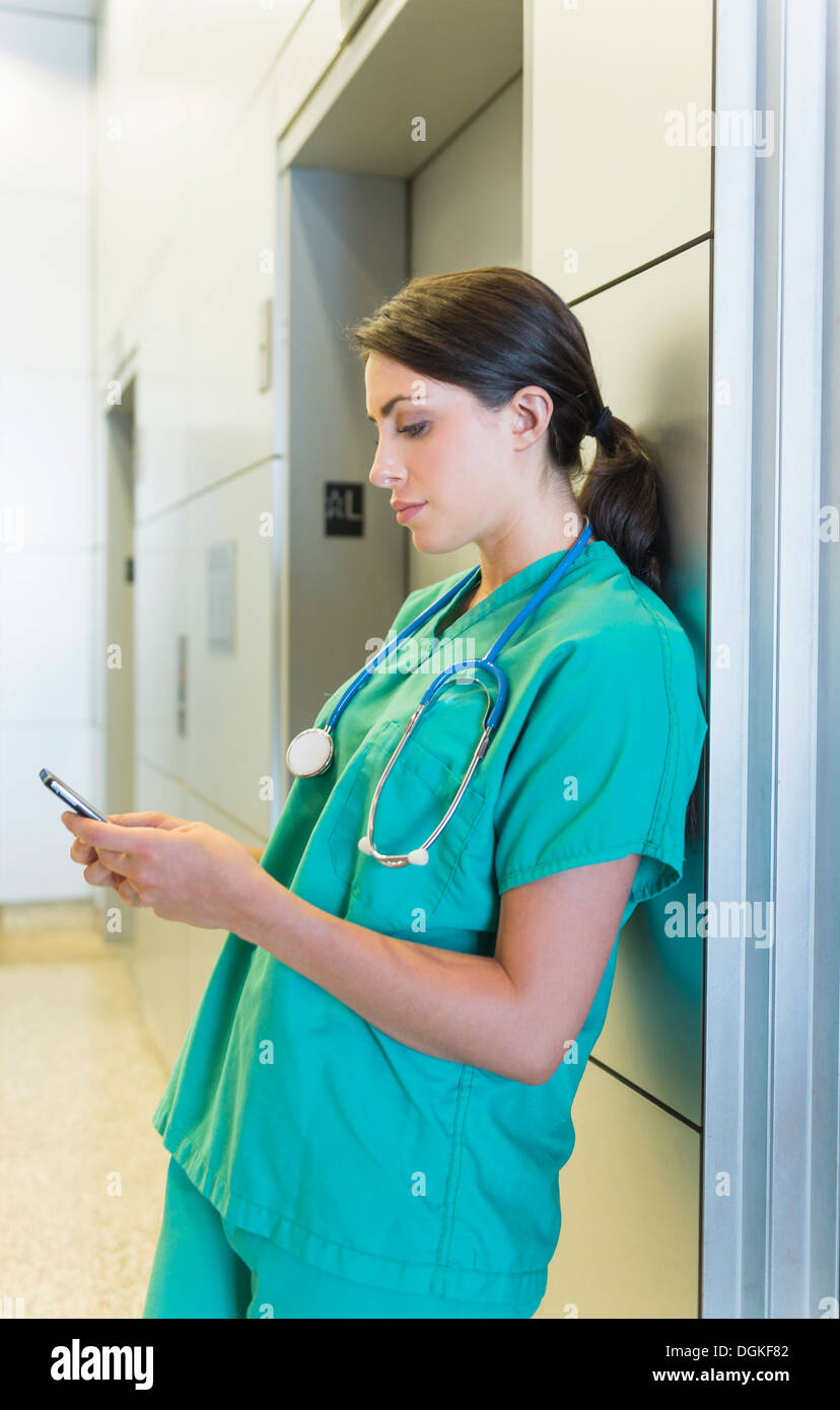 Female doctor text messaging Stock Photo - Alamy