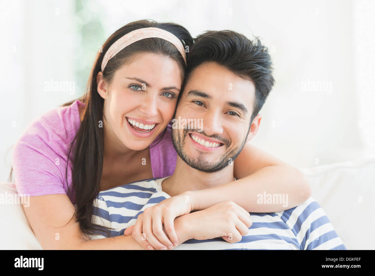 Romantic couple smiling hugging hi-res stock photography and images - Alamy