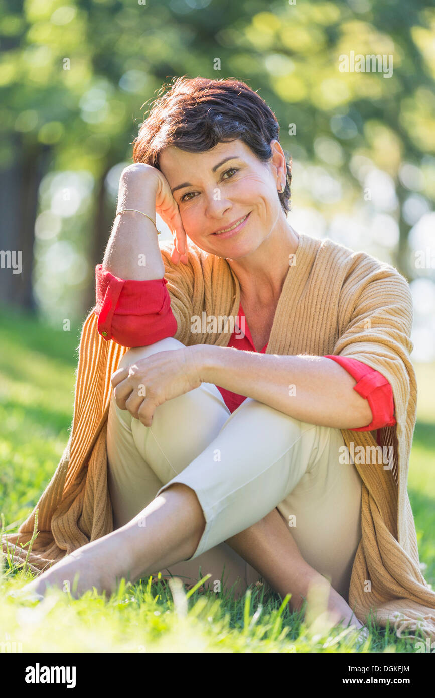 Mature woman sitting park hi-res stock photography and images - Alamy