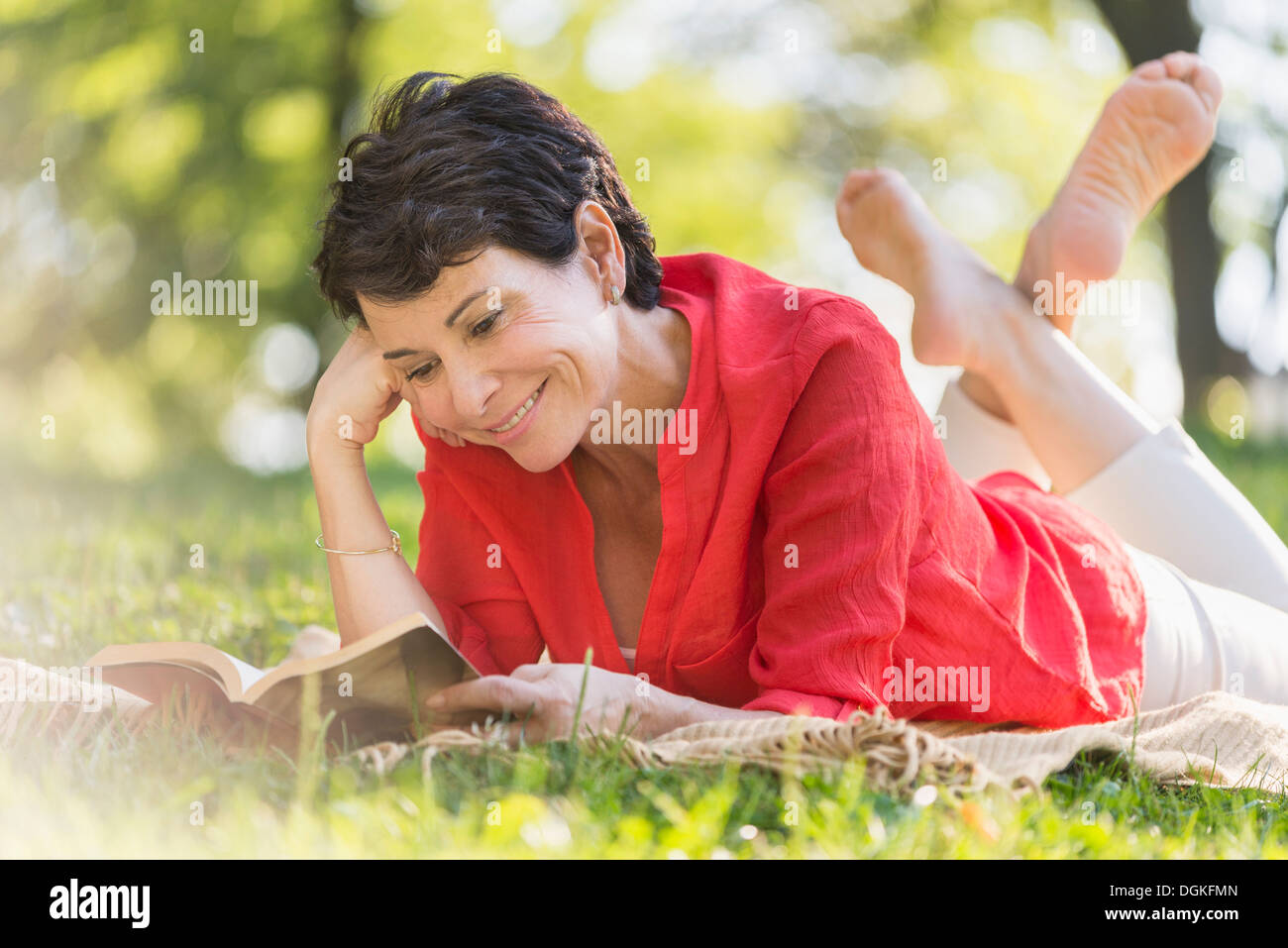 Girl Laying In Grass Reading