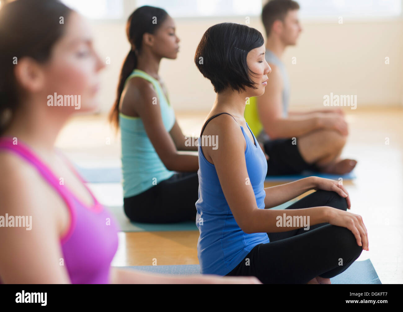 Group of young people meditating Stock Photo - Alamy
