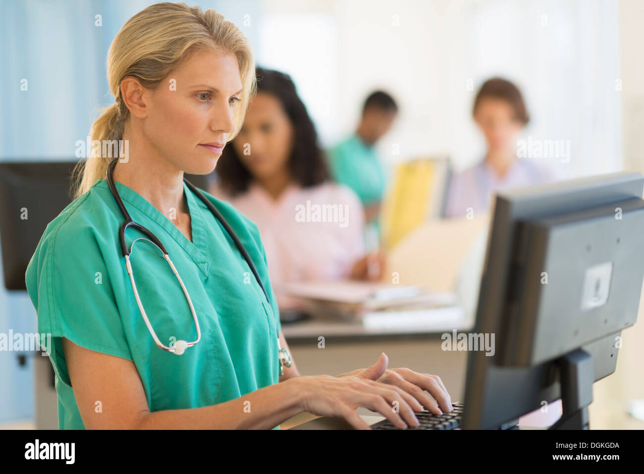 Doctor working at desks in hospital Stock Photo - Alamy