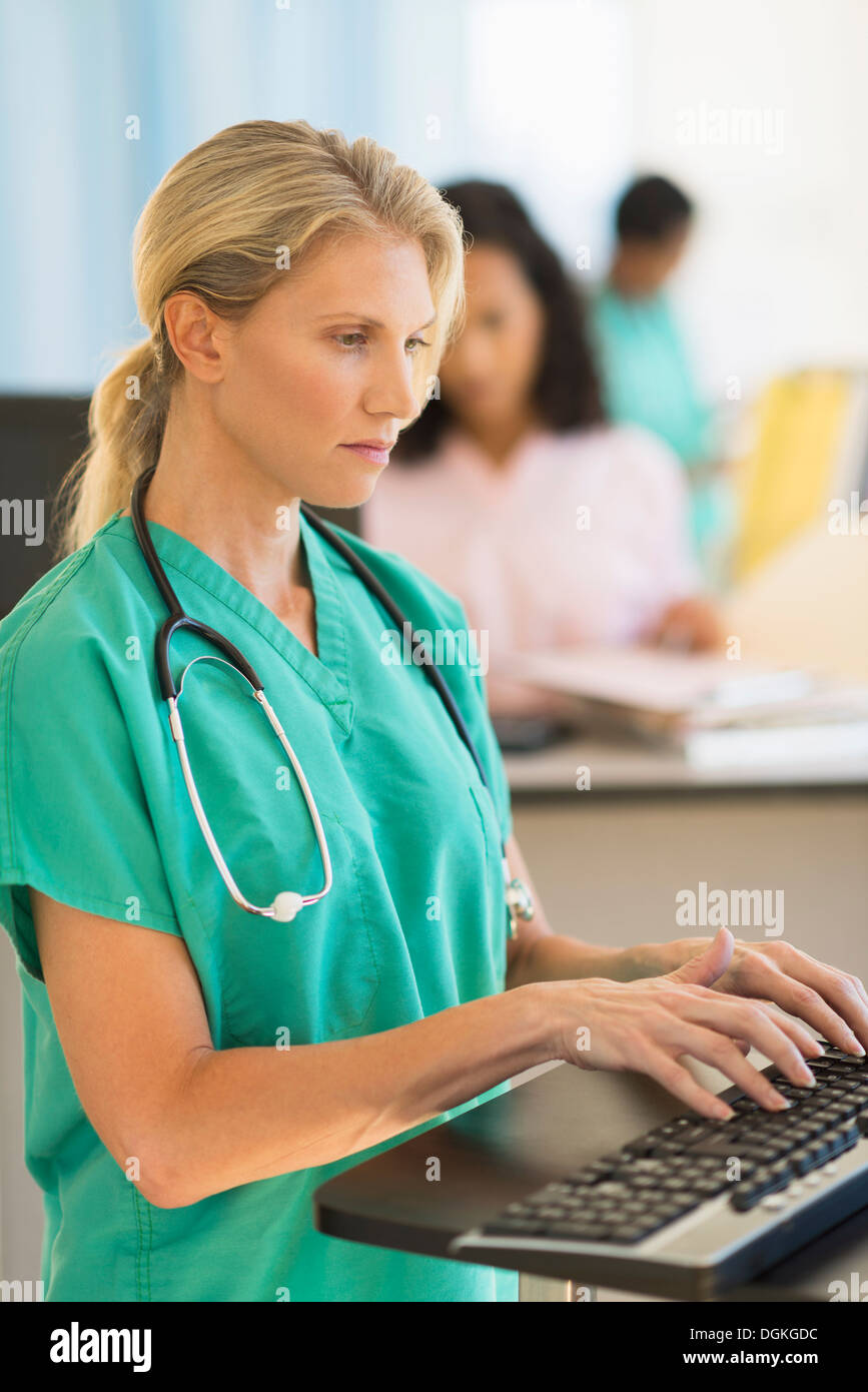 Doctor working at desks in hospital Stock Photo - Alamy