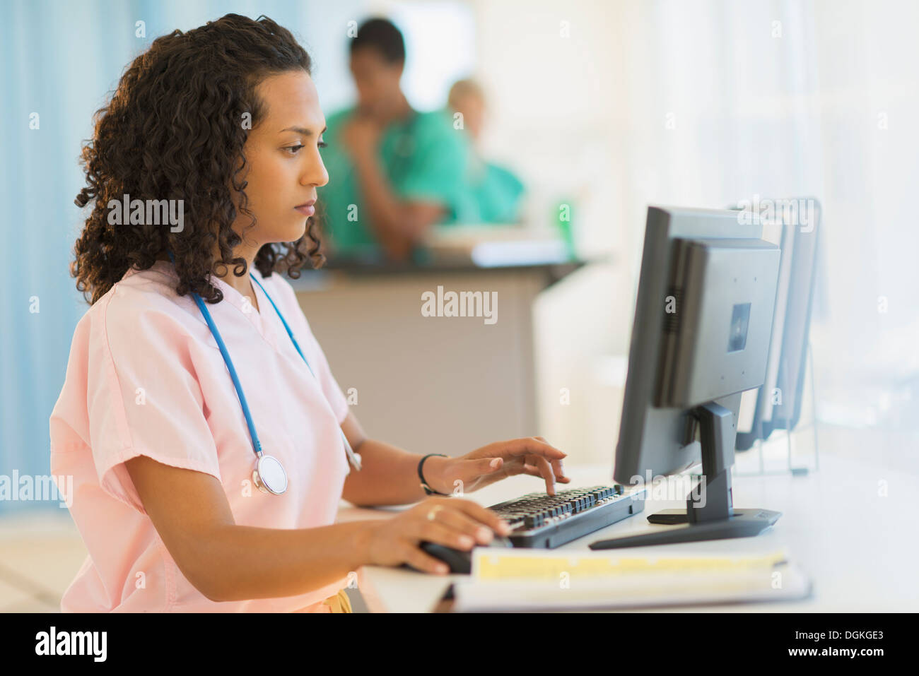 Doctor working at desks in hospital Stock Photo - Alamy