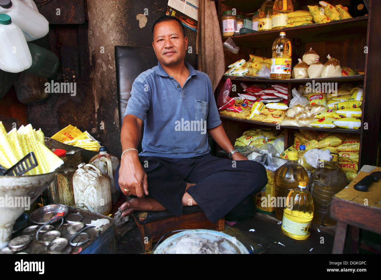 An oil seller sitting in his shop Stock Photo - Alamy