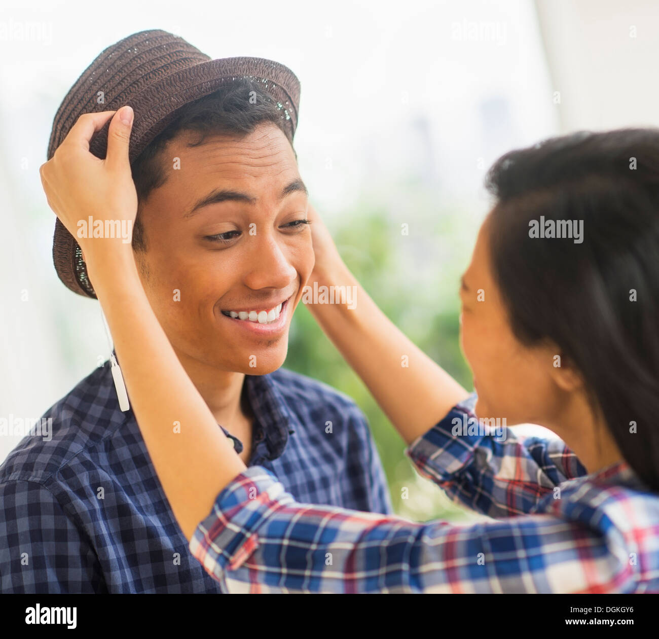 Young man trying on hat Stock Photo - Alamy Young man trying on hat Stock Photo - Alamy