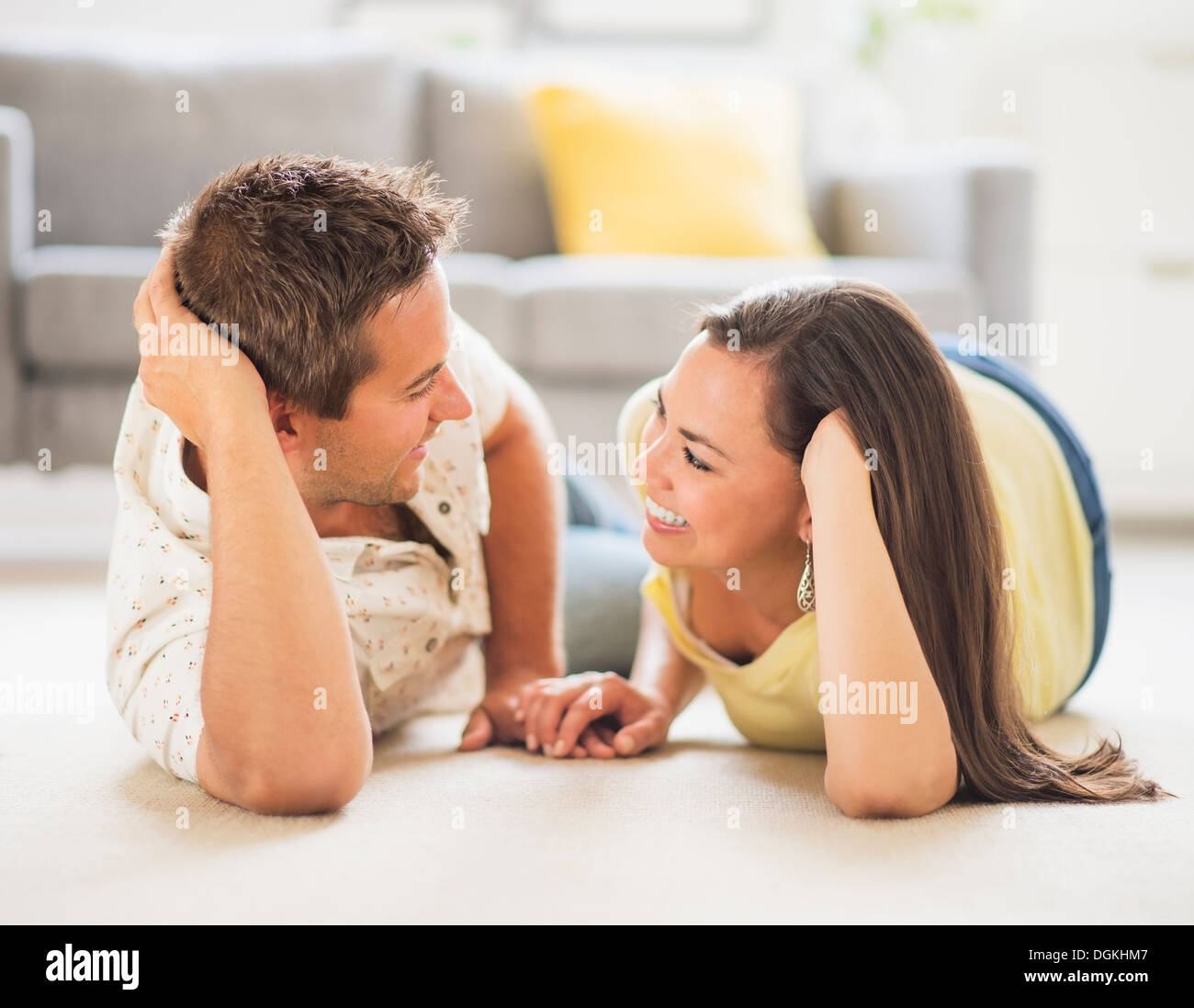 Portrait of happy couple lying on side, face to face Stock Photo - Alamy