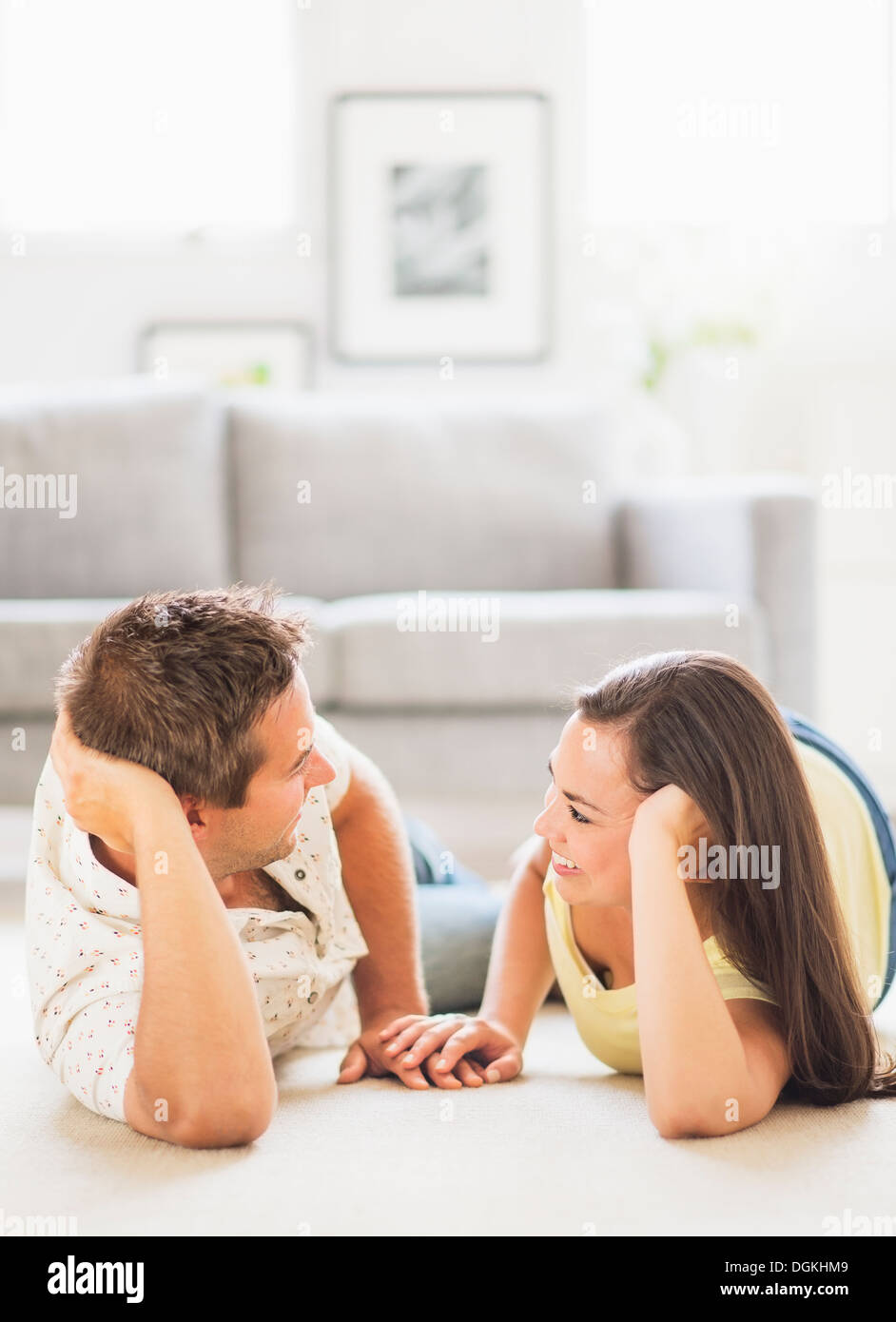 Portrait of happy couple lying on side, face to face Stock Photo - Alamy