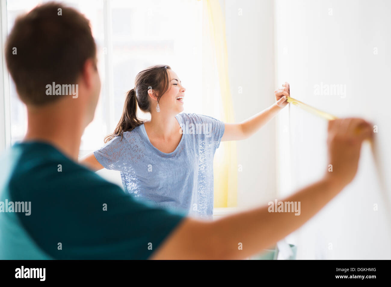 Woman measuring wall measuring tape hi-res stock photography and images ...