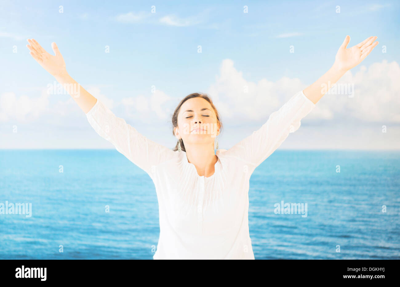 Woman arms raised closed eyes hi-res stock photography and images - Alamy