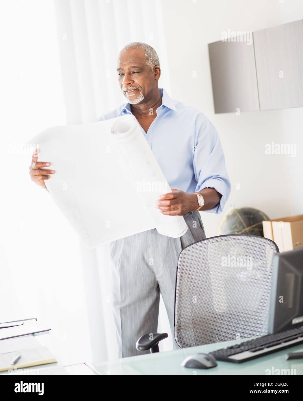 Contented male architect blueprint hi-res stock photography and images ...