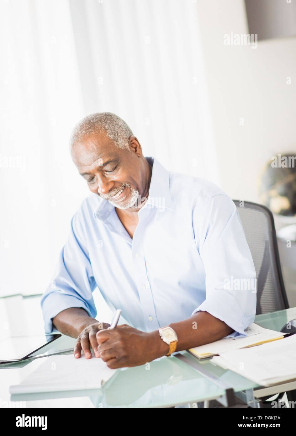 African man writing on paper hi-res stock photography and images - Alamy