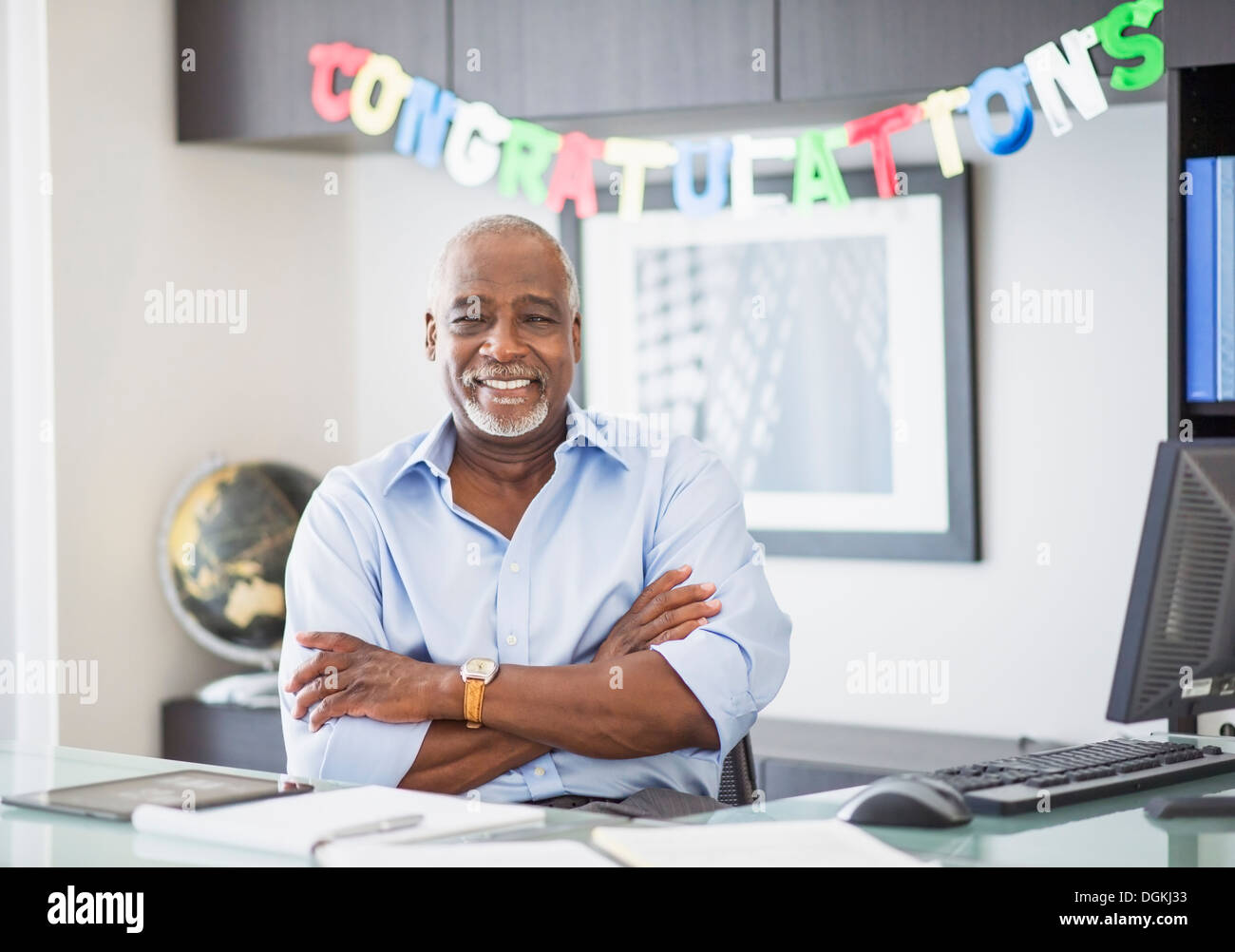 Portrait of man in office, congratulations sign behind Stock Photo - Alamy