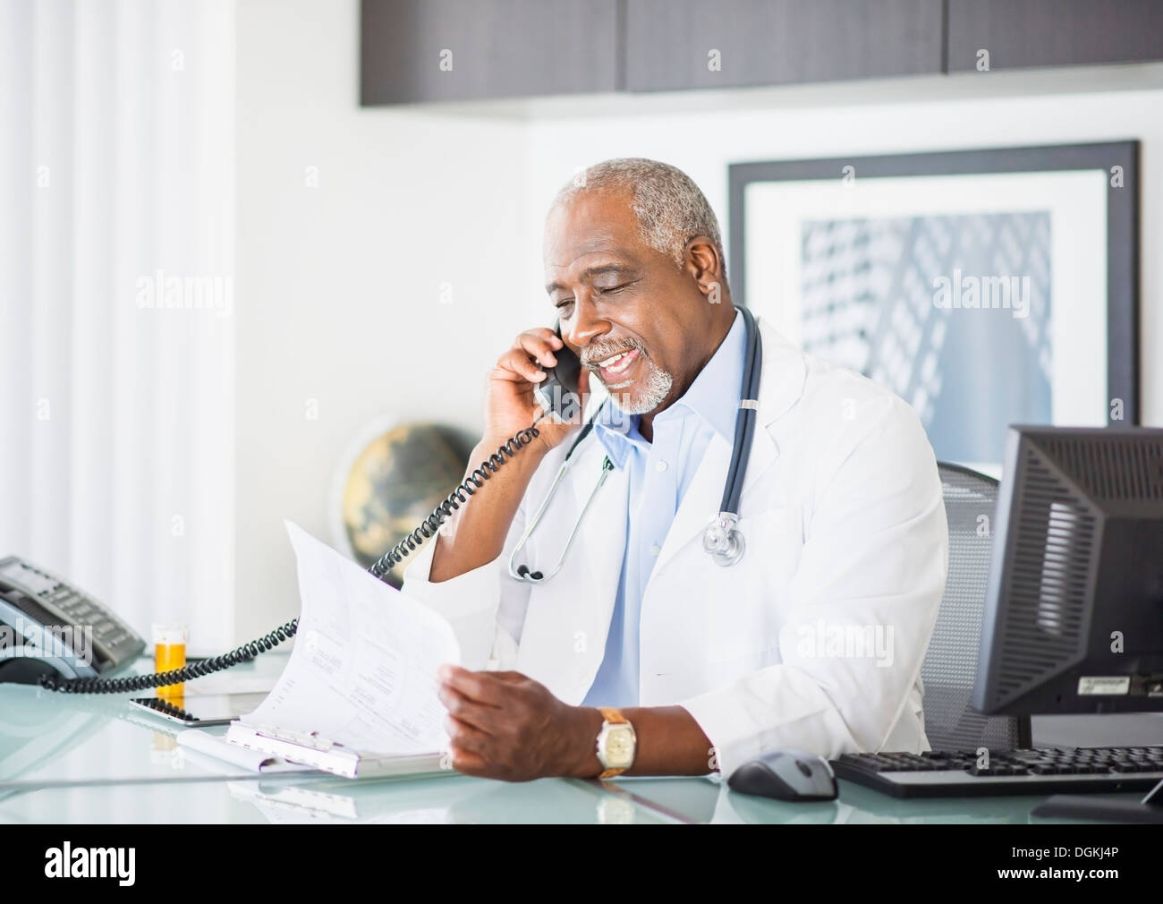 Male doctor sitting phone hi-res stock photography and images - Alamy