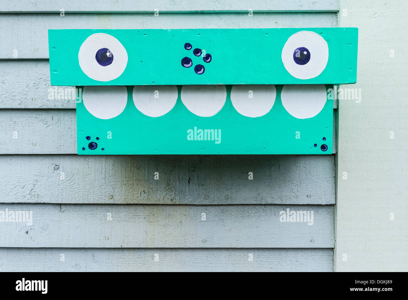 A custom made mailbox painted turquoise with eyes and teeth on the ...