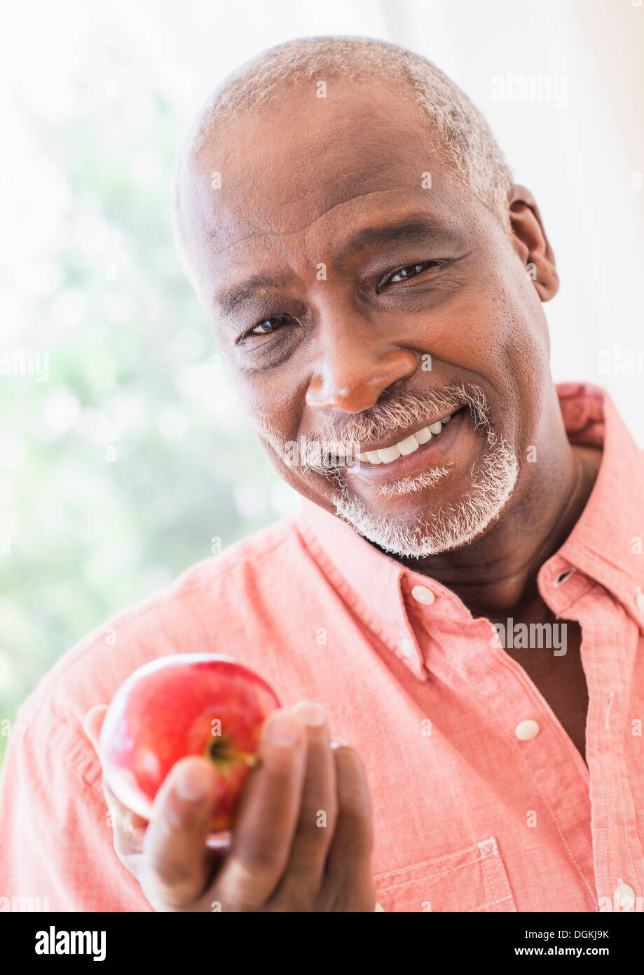 Portrait of man holding red apple Stock Photo - Alamy