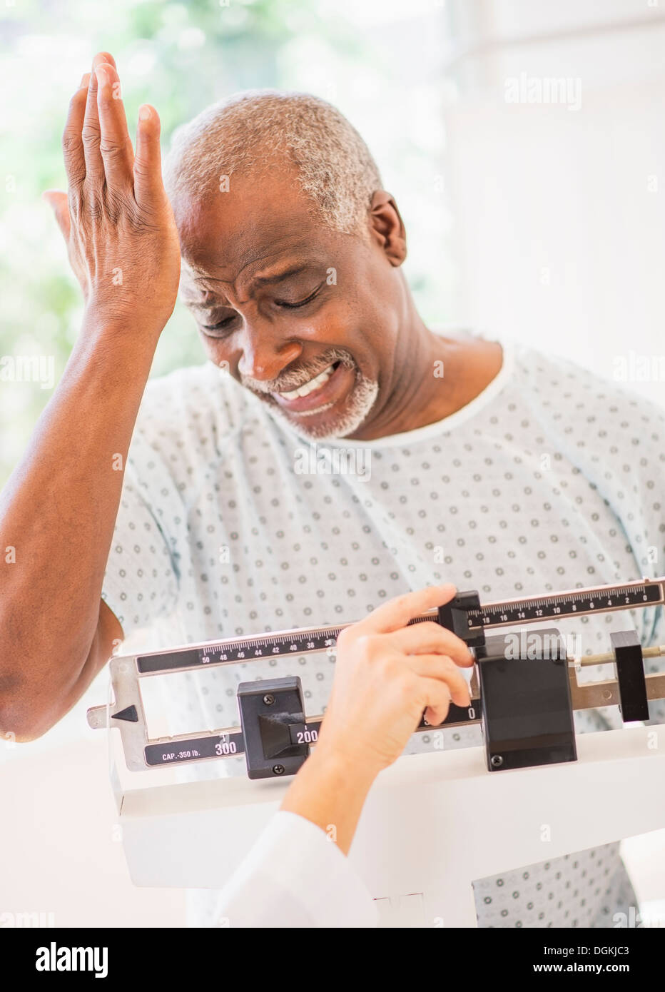 African man standing on scale hi-res stock photography and images - Alamy