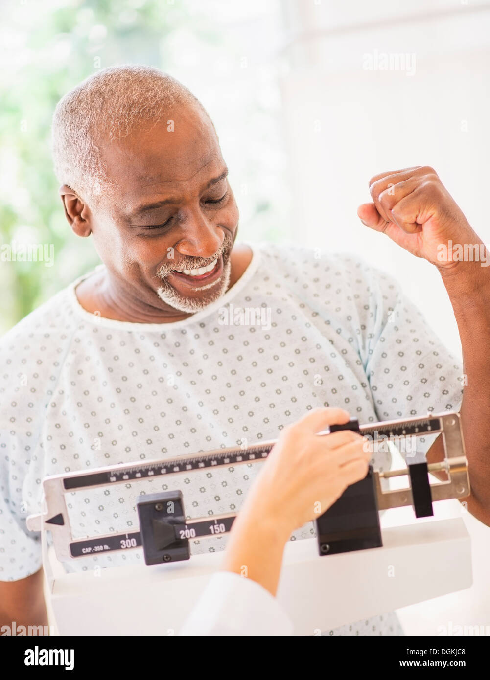 Happy man on weight scale Stock Photo - Alamy