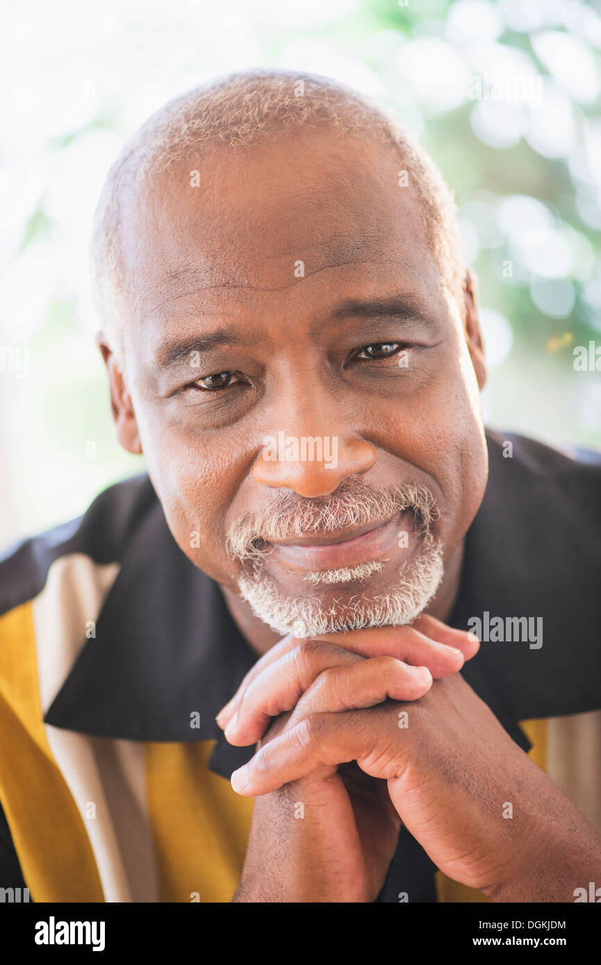 Portrait of senior man with hands clasped Stock Photo - Alamy