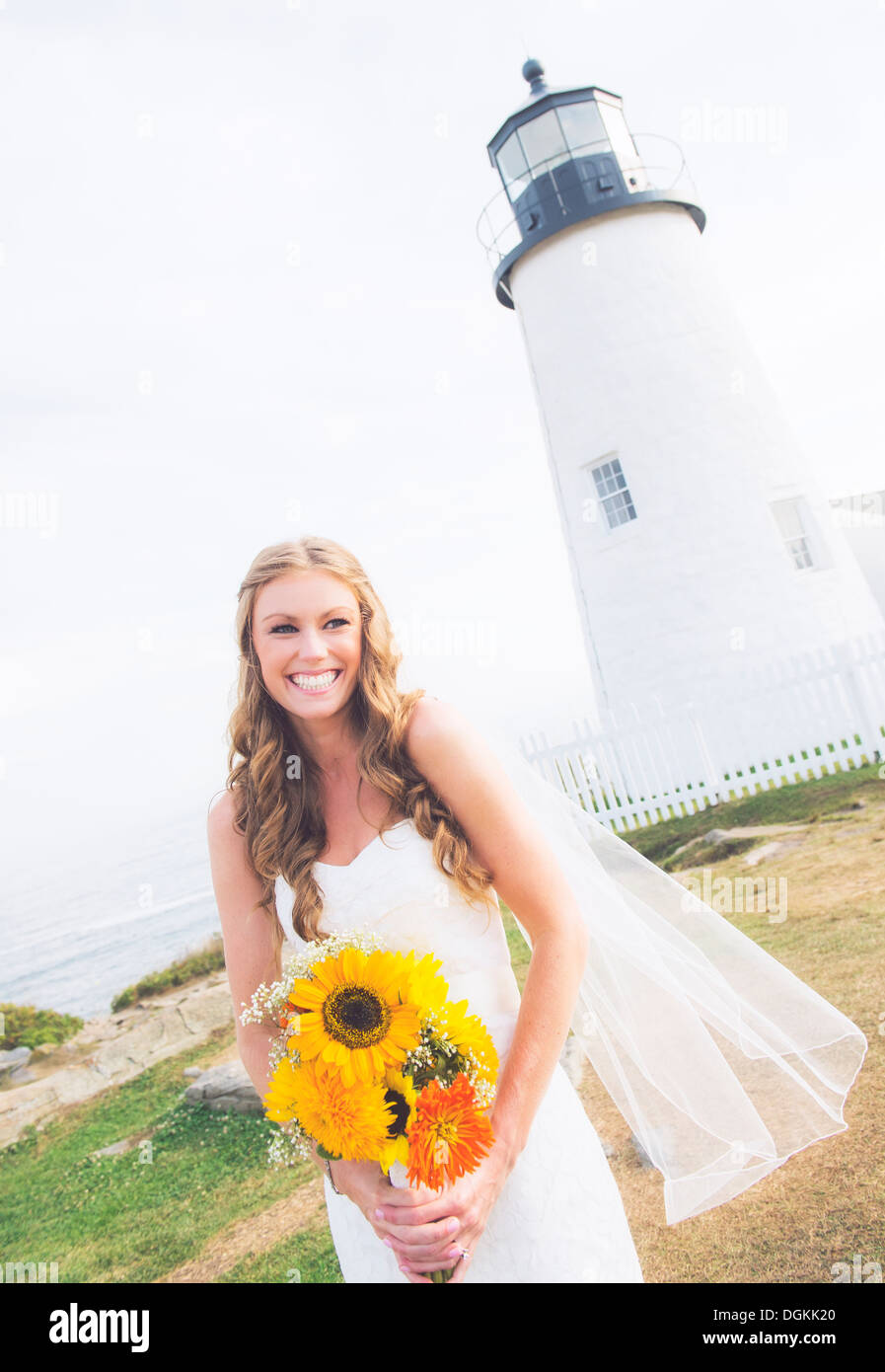 USA, Maine, Bristol, Portrait of smiling bride holding sunflower ...